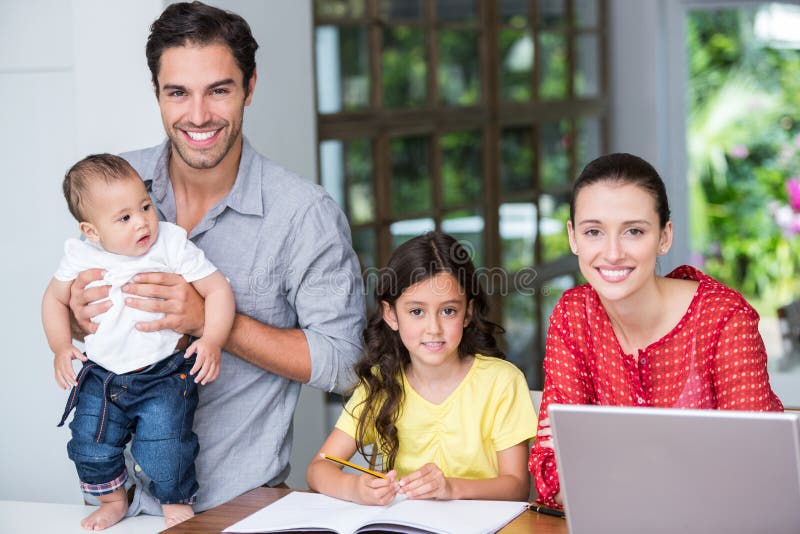Smiling family at desk stock image. Image of apartment - 68200725