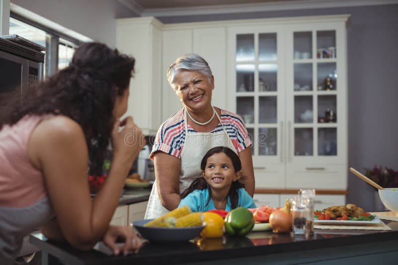 Smiling Family Interacting with Each Other in Kitchen Stock Photo ...