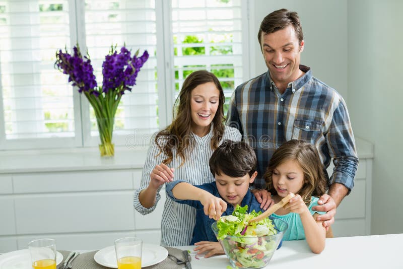 Smiling Family Preparing Bowl of Salad in Kitchen Stock Image - Image ...