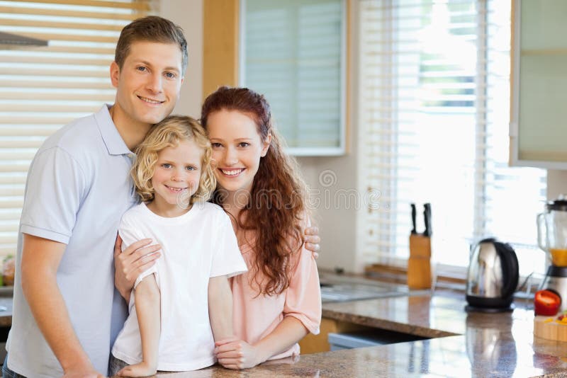 Smiling Family Standing Behind the Kitchen Counter Stock Image - Image ...