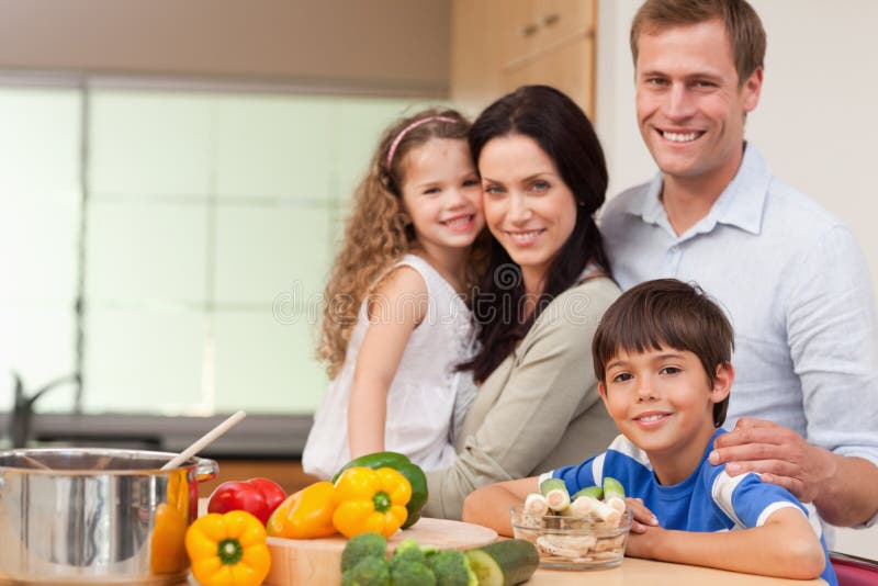 Smiling Family Standing in the Kitchen Stock Photo - Image of family ...