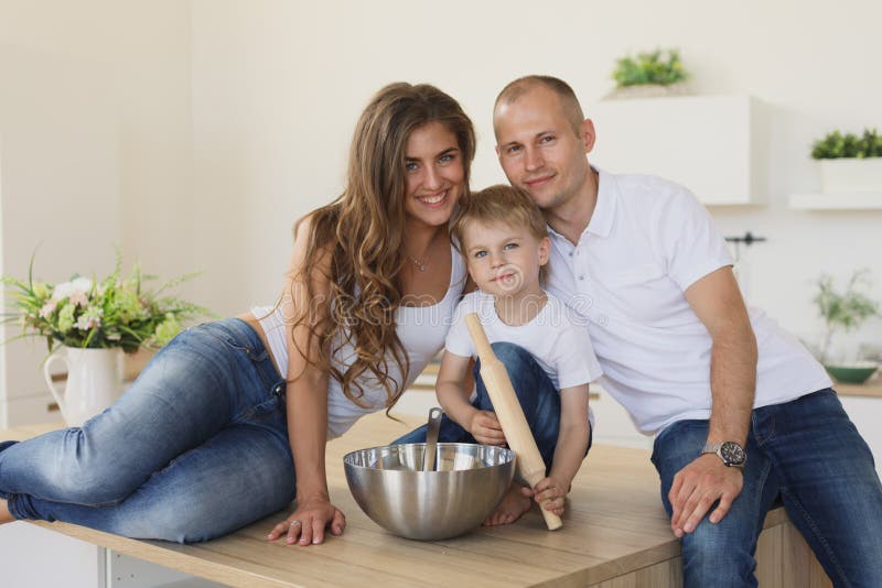 Smiling Family Standing in the Kitchen Together Stock Image - Image of ...