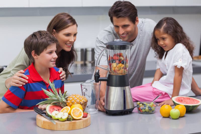 Smiling Family Using a Blender Stock Photo - Image of attractive, food ...