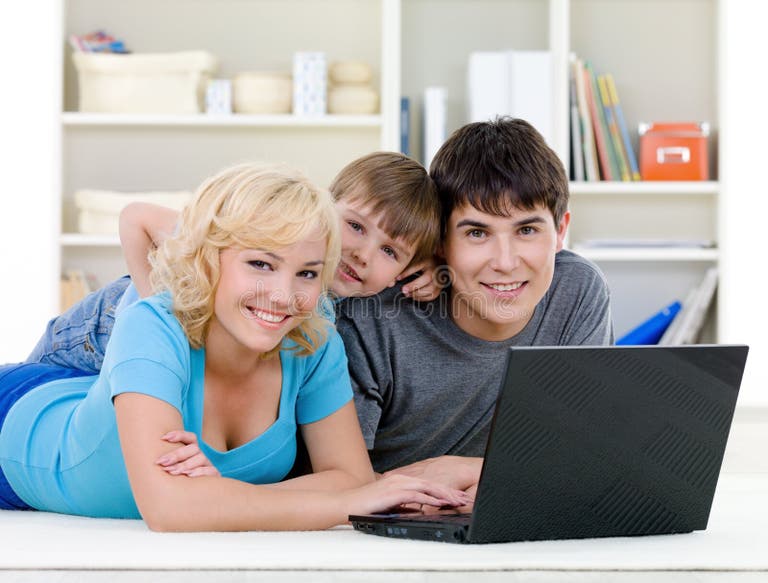 Smiling Family Using Laptop Stock Photo - Image of casual, family: 15038948