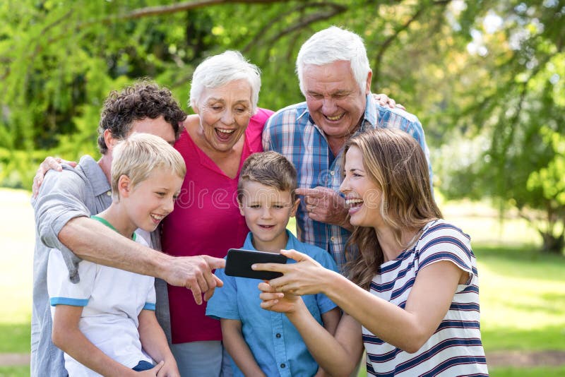 Smiling Family Using Smartphone Stock Photo - Image of finger, mobile ...