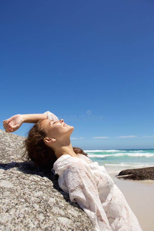 Smiling Fashion Model Looking Up at the Beach Stock Photo - Image of ...