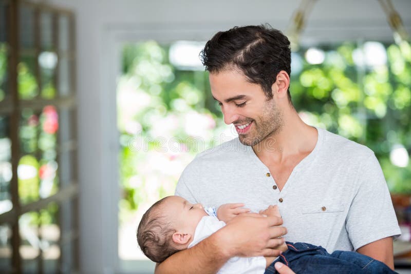 Smiling Father Carrying Baby Stock Photo - Image of mixedrace ...