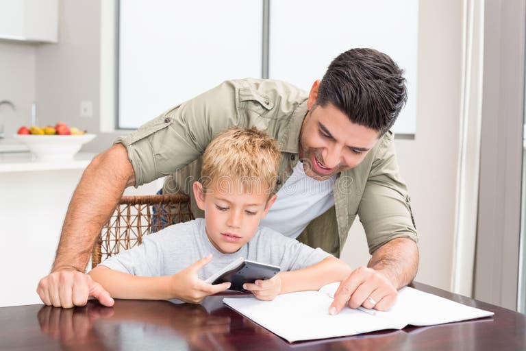 Smiling Father Helping Son with Math Homework at Table Stock Image ...