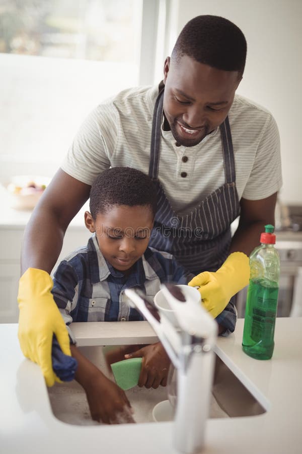 Smiling Father and Son Cleaning Utensils in Kitchen Stock Photo - Image ...