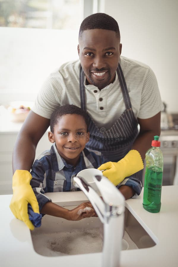 Smiling Father and Son Cleaning Utensils in Kitchen Stock Image - Image ...