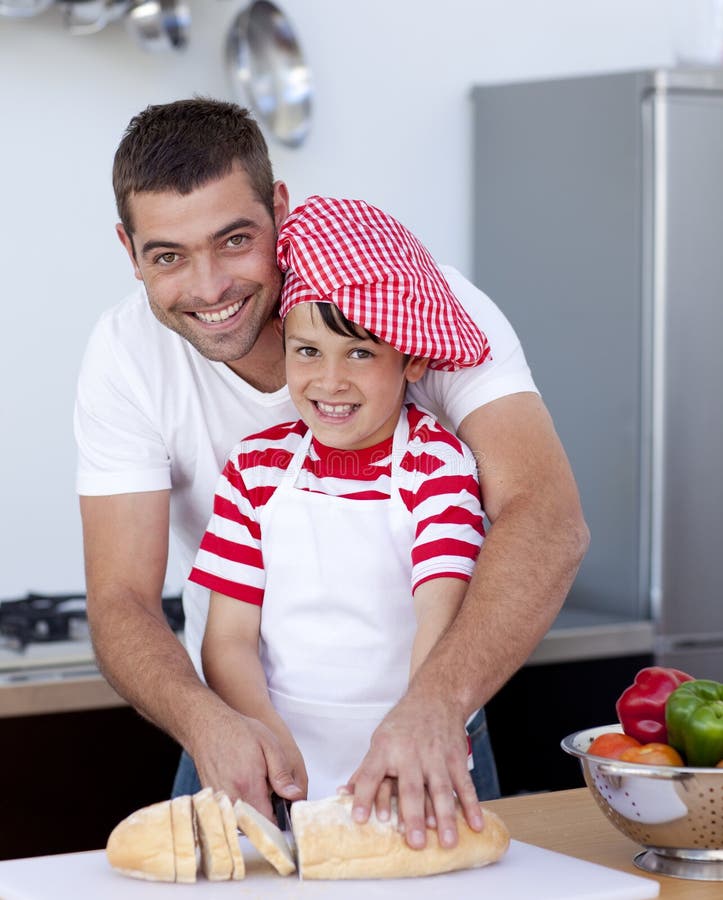Smiling Father and Son Cutting Bread Stock Image - Image of father ...