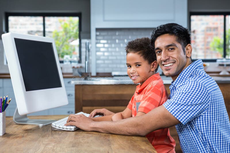 Smiling Father Using Computer with His Son Stock Photo - Image of ...