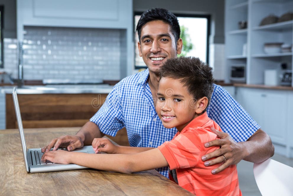 Smiling Father Using Laptop with His Son Stock Image - Image of laptop ...