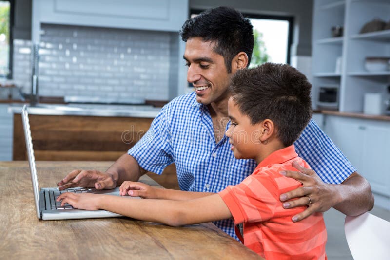 Smiling Father Using Laptop with His Son Stock Image - Image of kitchen ...