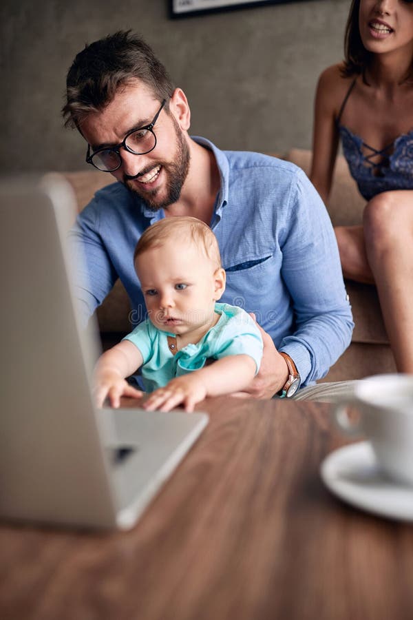 Smiling Father Working with Computer while Looking after His Baby Son ...