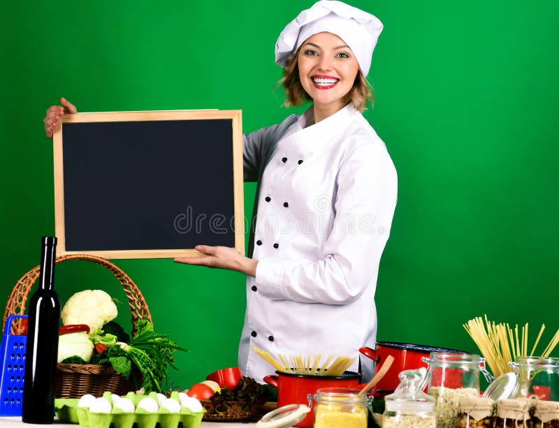 Smiling Female Chef with Empty Blackboard for Advertising Healthy Menu ...