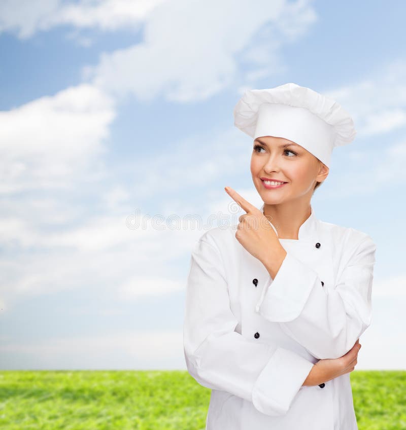 Smiling Female Chef Pointing Finger To Sonething Stock Photo - Image of ...