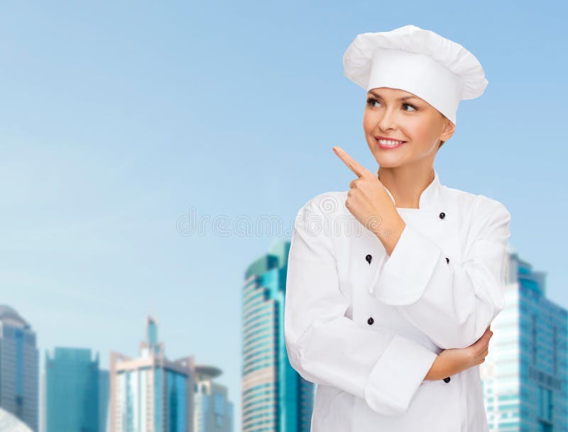 Smiling Female Chef Pointing Finger To Sonething Stock Image - Image of ...