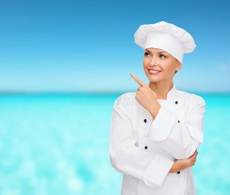 Smiling Female Chef Pointing Finger To Sonething Stock Image - Image of ...