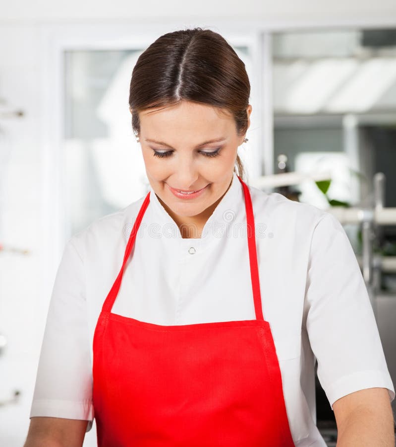 Smiling Female Chef in Red Apron at Kitchen Stock Image - Image of ...
