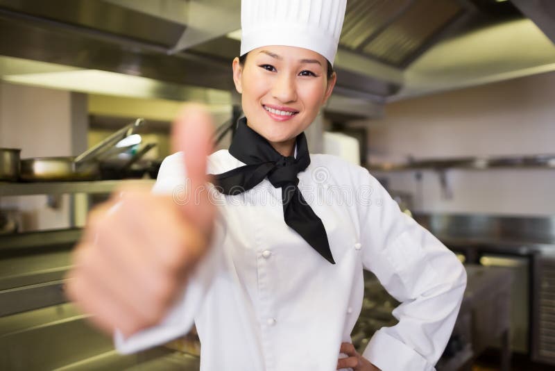 Smiling Female Cook Gesturing Thumbs Up in Kitchen Stock Image - Image ...