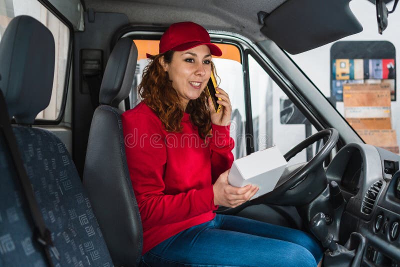 Smiling Female Delivery Driver Calling Someone about Their Pack Stock ...