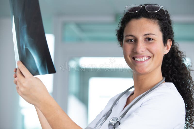 Smiling Female Doctor Studying X-ray Stock Photo - Image of looking ...