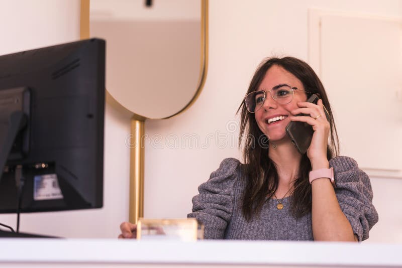 Smiling Female Employee Having Phone Call during Work on Computer in ...