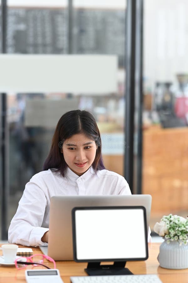Female Employee Sitting in Modern Office and Working with Laptop ...