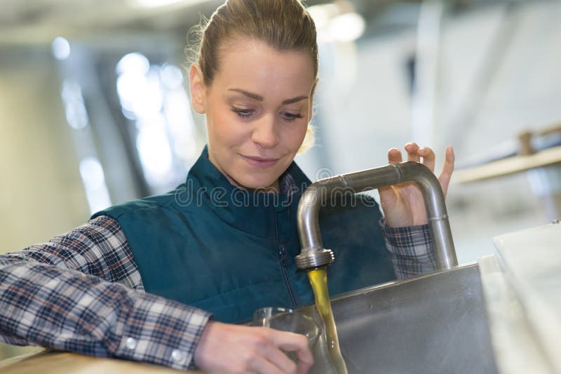 Smiling Female Engineer Next To Tank Inside Factory Stock Photo - Image ...