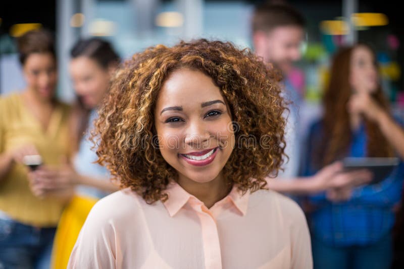 Smiling Female Executive in Office Stock Photo - Image of mixedrace ...