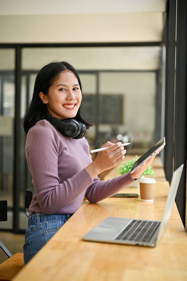 A Smiling Female Freelancer Remote Working at the Coffee Shop, Using ...