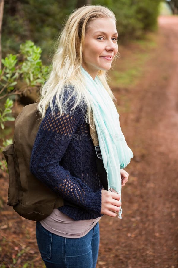 Smiling Female Hiker Waiting by the Side of the Road Stock Photo ...