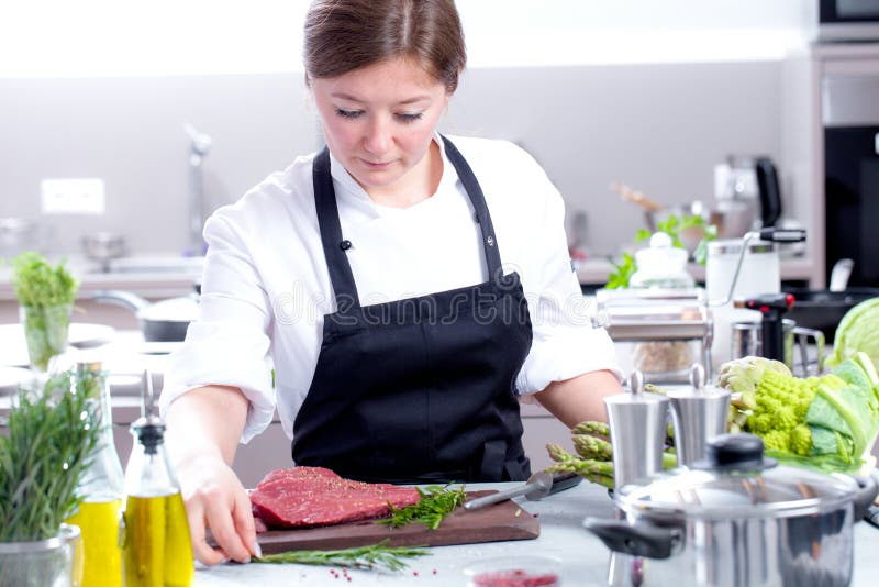 Smiling Female Kitchener in Uniform is Standing in the Kitchen at the ...