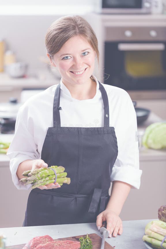 Smiling Female Kitchener in Uniform is Standing in the Kitchen at the ...