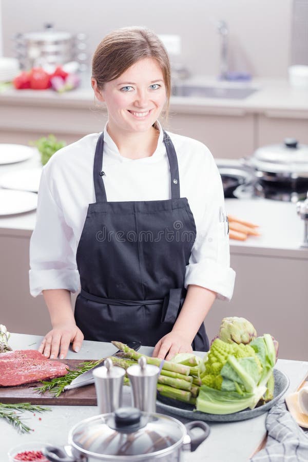 Smiling Female Kitchener in Uniform is Standing in the Kitchen at the ...