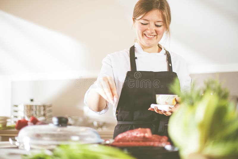 Smiling Female Kitchener in Uniform is Standing in the Kitchen at the ...