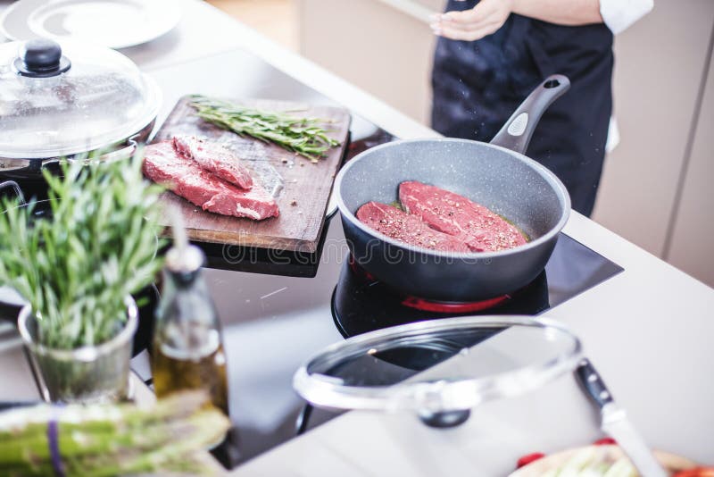 Smiling Female Kitchener in Uniform is Standing in the Kitchen at the ...