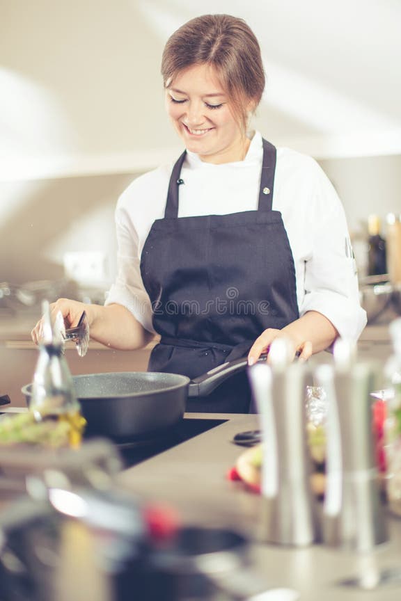 Smiling Female Kitchener in Uniform is Standing in the Kitchen at the ...