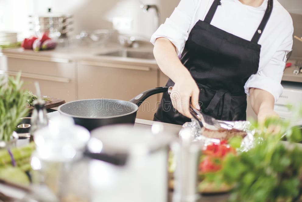 Smiling Female Kitchener in Uniform is Standing in the Kitchen at the ...