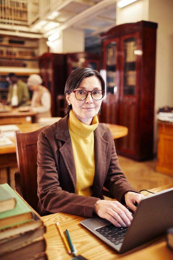 Smiling Female Librarian at Workplace Stock Image - Image of community ...