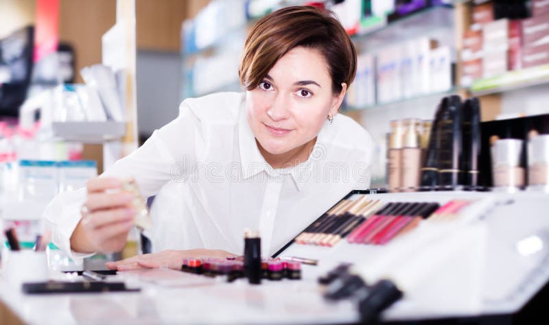 Smiling Female Looking for Make-up Items Stock Photo - Image of ...