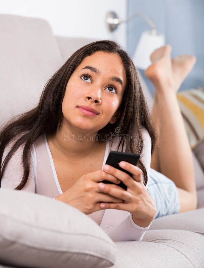 Smiling Female with Mobile Phone on Sofa Stock Image - Image of casual ...