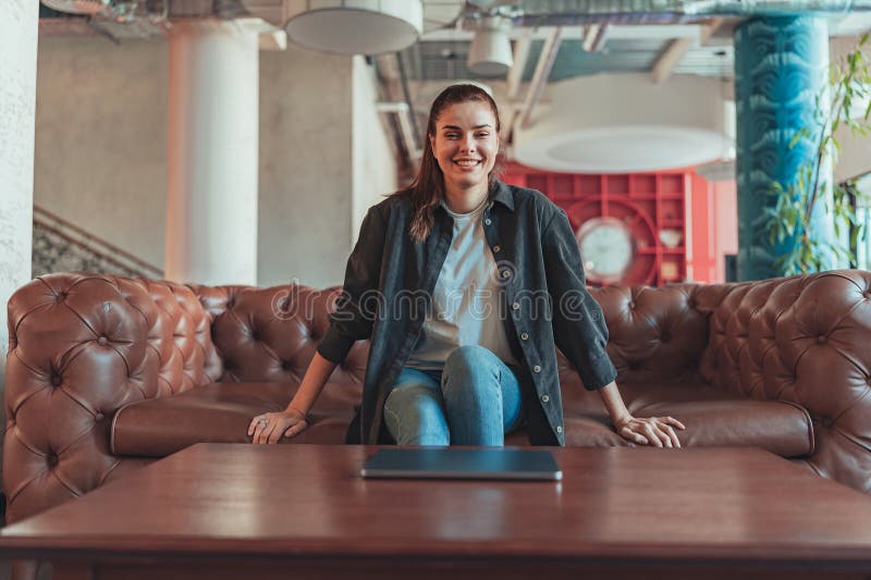 Female Freelancer Enjoying Rest Break in Co-working Space and Looking ...