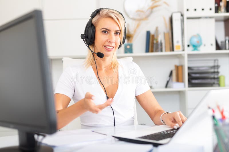Female Operator Talking with Customer Using Headset at Company Office ...