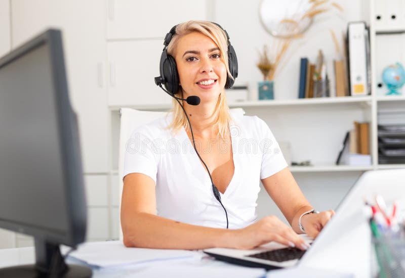 Female Operator Talking with Customer Using Headset at Company Office ...