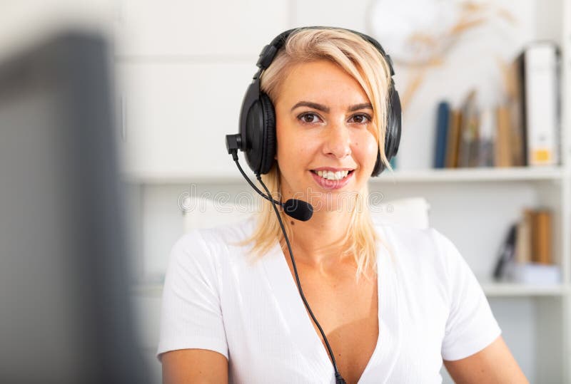 Female Operator Talking with Customer Using Headset at Company Office ...
