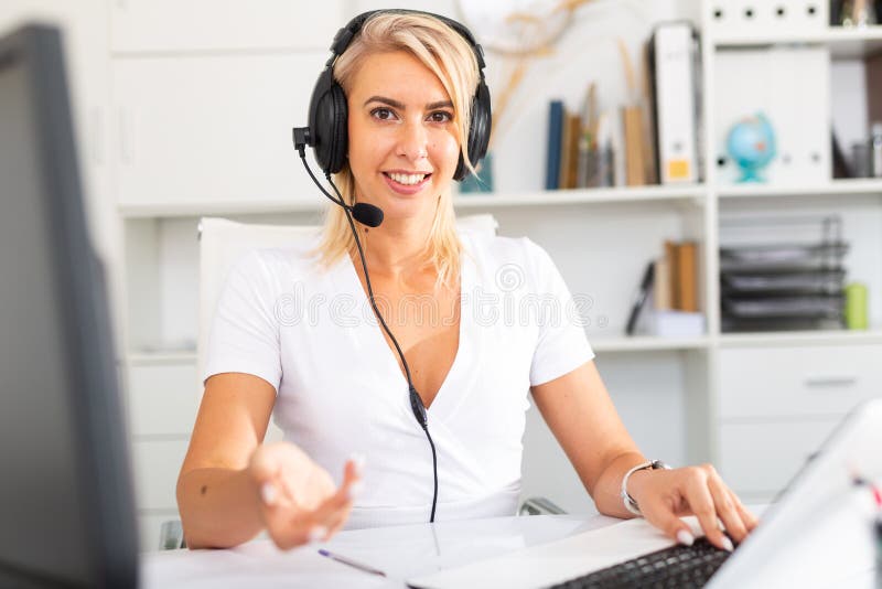 Female Operator Talking with Customer Using Headset at Company Office ...