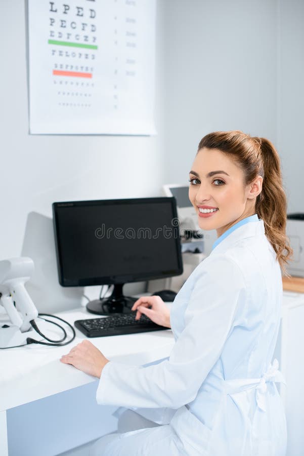 Smiling Female Optician Working with Computer Stock Image - Image of ...