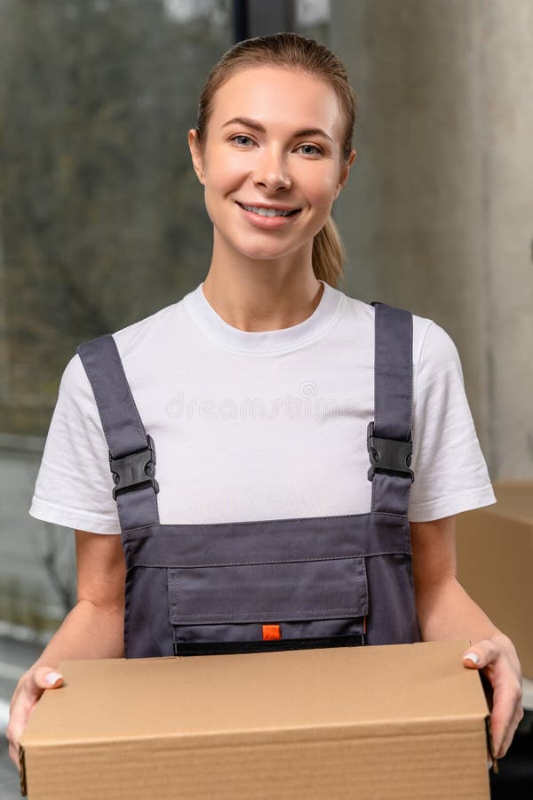 Smiling Female Packaging Center Worker with a Parcel in Hands Stock ...